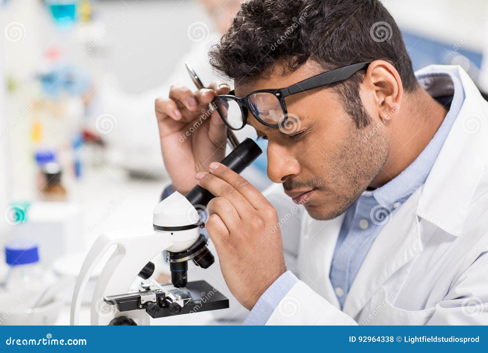 Scientist in Eyeglasses Working with Microscope in Research Laboratory ...