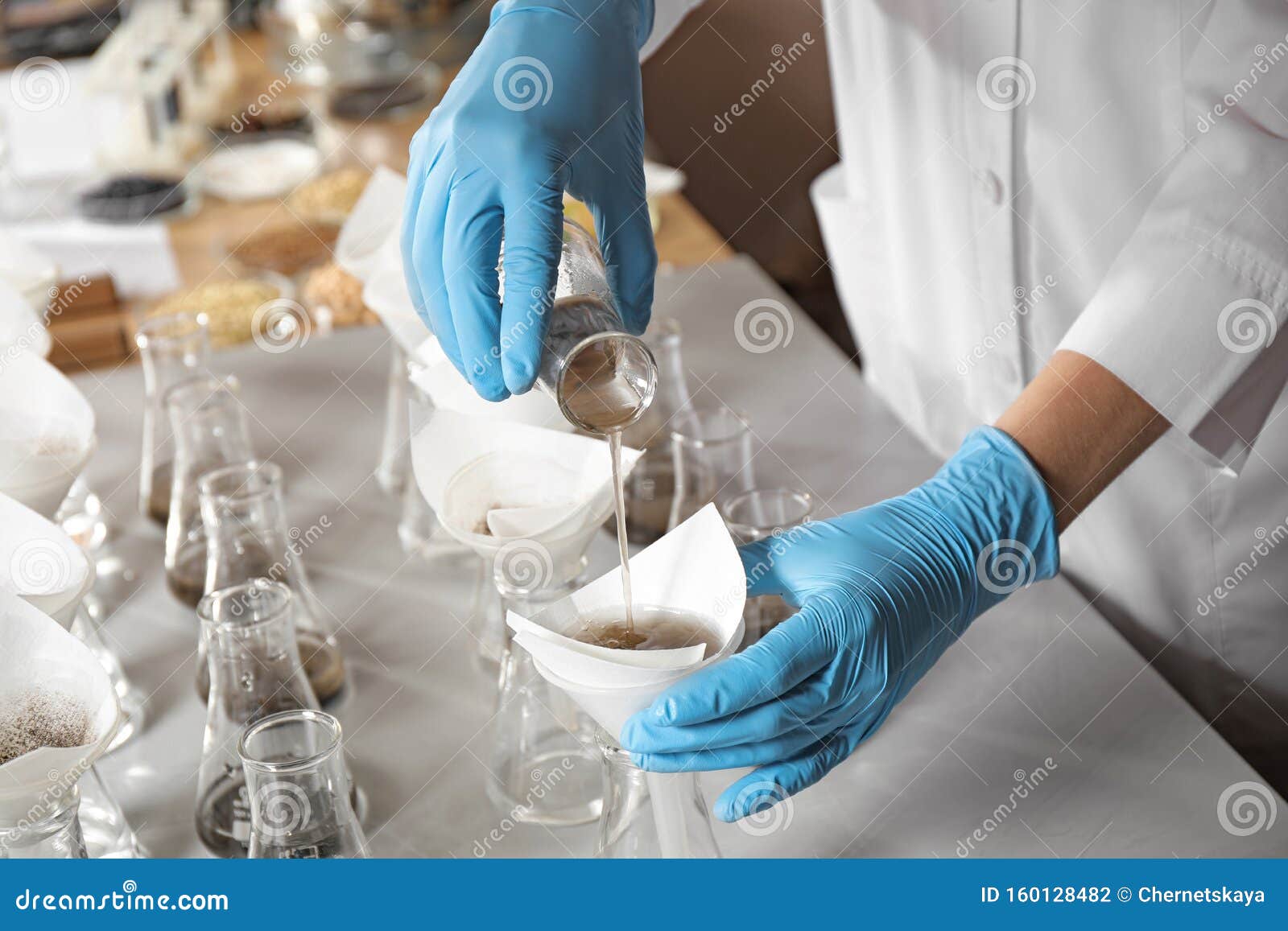 Scientist Filtering Soil Samples at Table. Laboratory Analysis Stock ...
