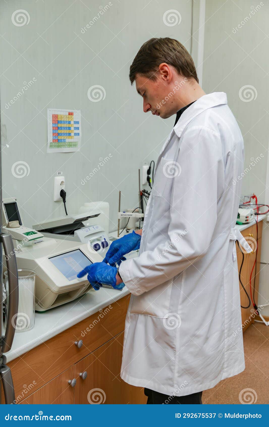 Scientist with Gloved Hand Putting DNA Sample into Real-time PCR-cycler ...