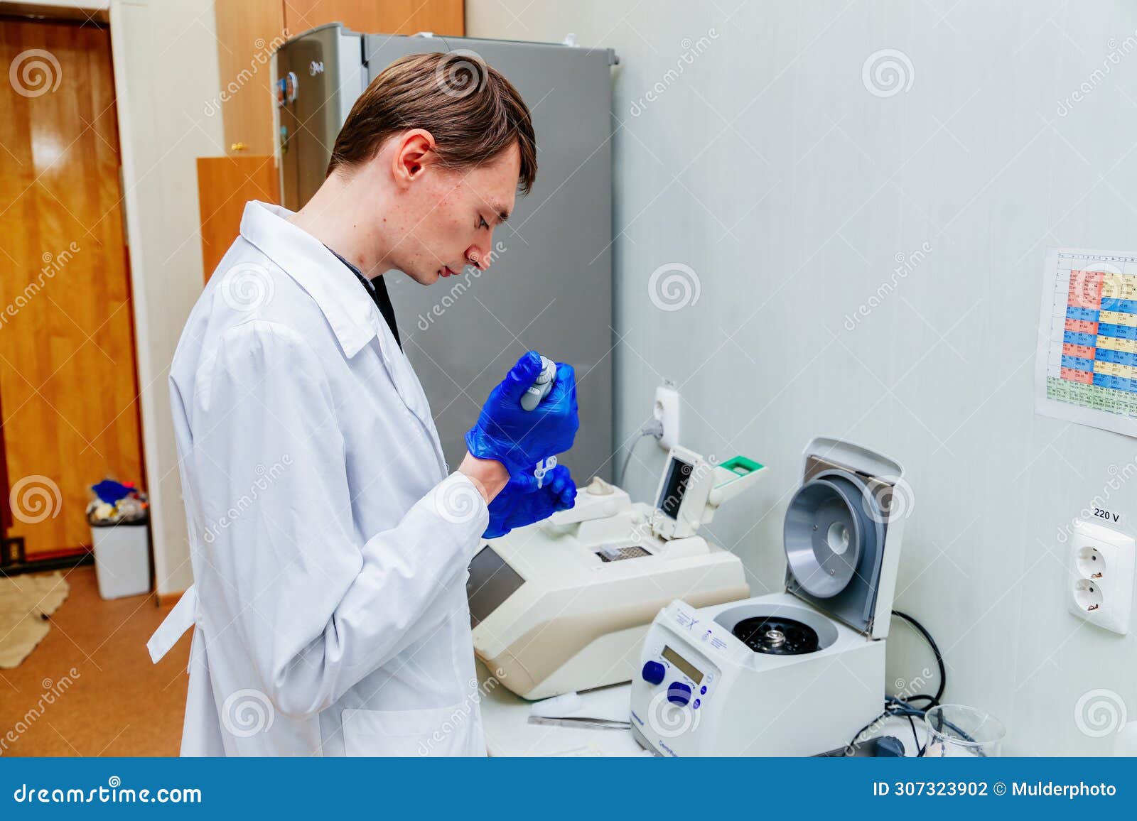 Scientist with Gloved Hand Putting DNA Sample into Real-time PCR-cycler ...
