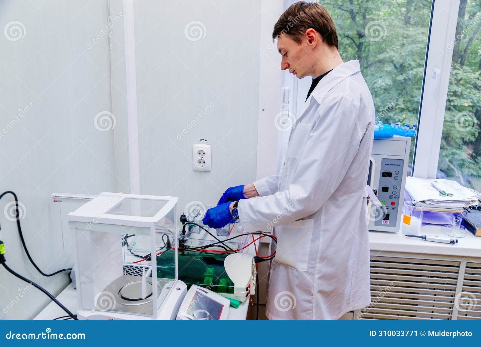 Scientist with Gloved Hand Putting DNA Sample into Real-time PCR-cycler ...