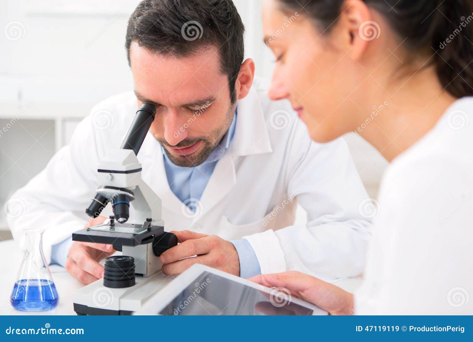 Scientist and Her Assistant in a Laboratory Stock Image - Image of ...