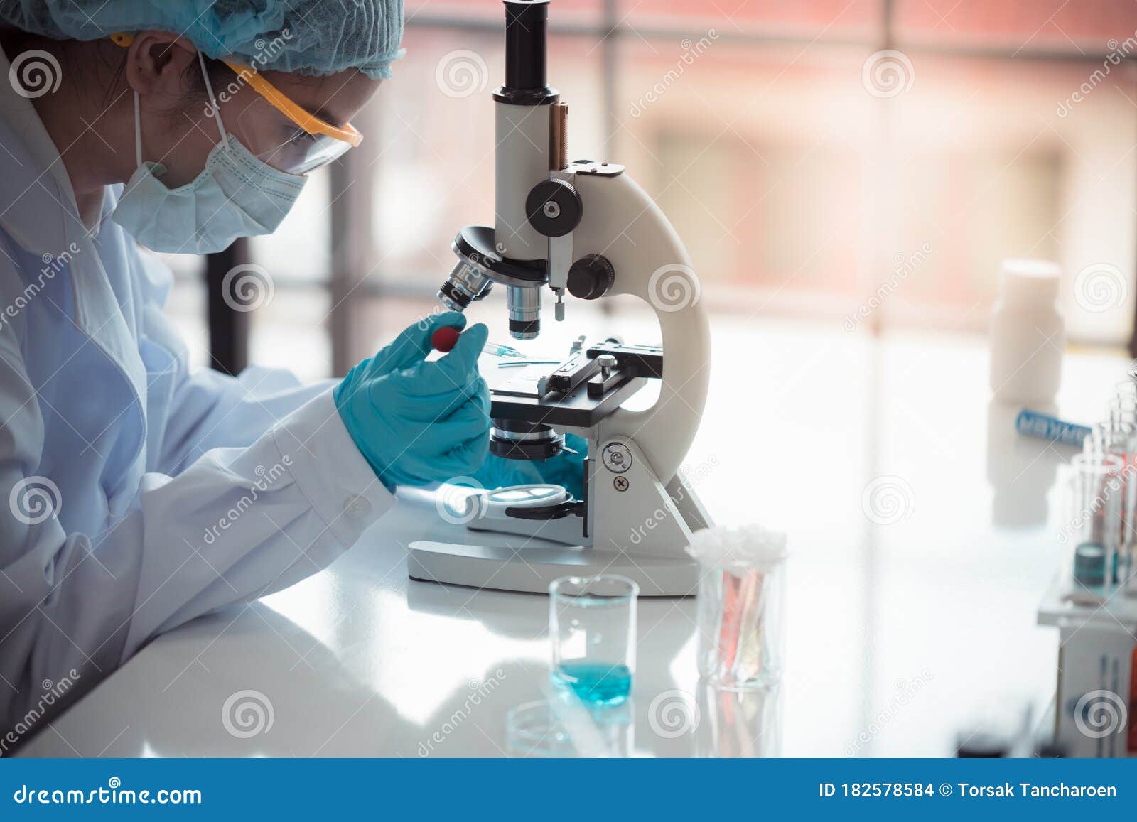Scientist Hold Pipette Adding Fluid To Test on Microscope Stock Photo ...