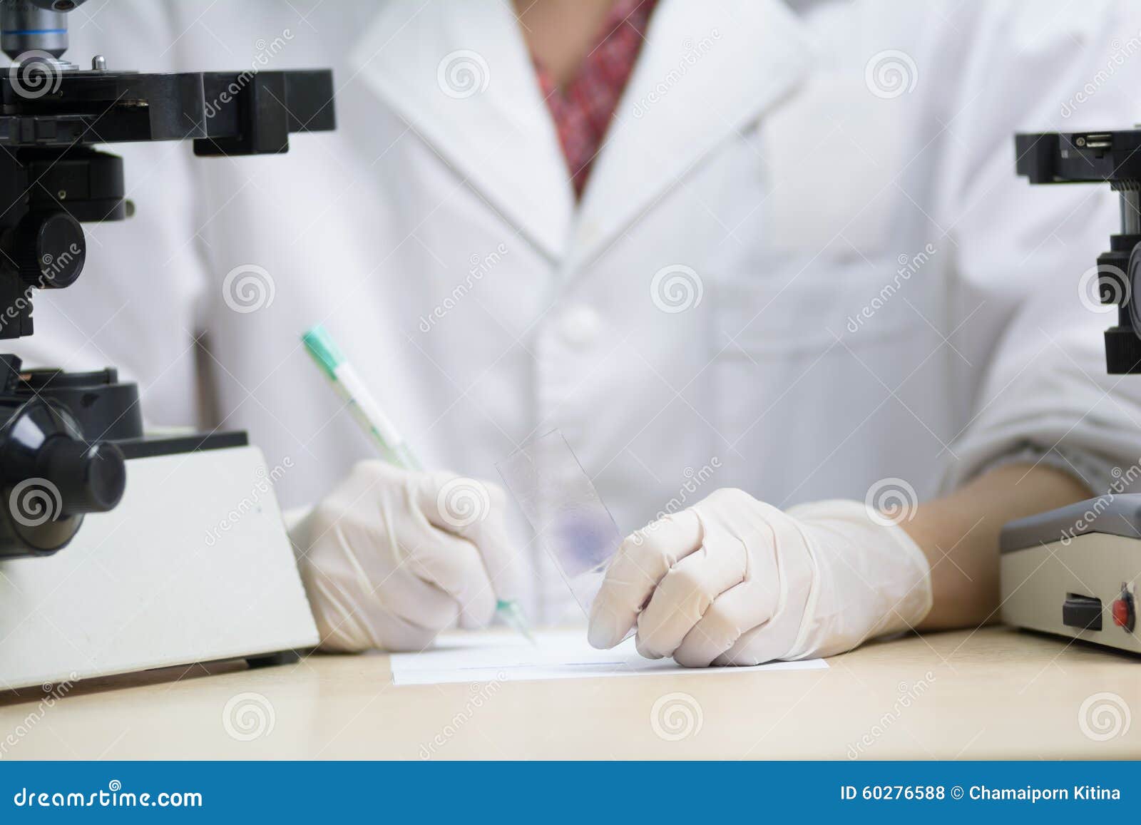 Scientist Hold Slide in Left Hand and Write Something Down Stock Photo ...
