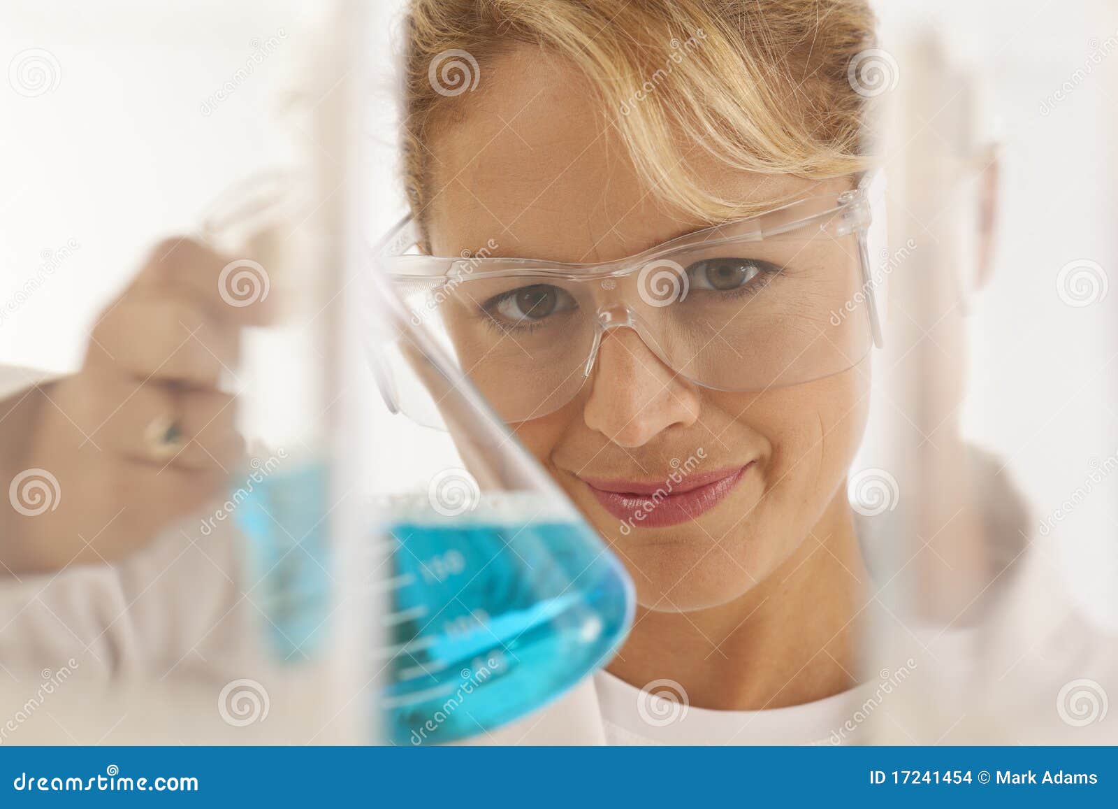 Scientist holding beaker stock photo. Image of viewing - 17241454
