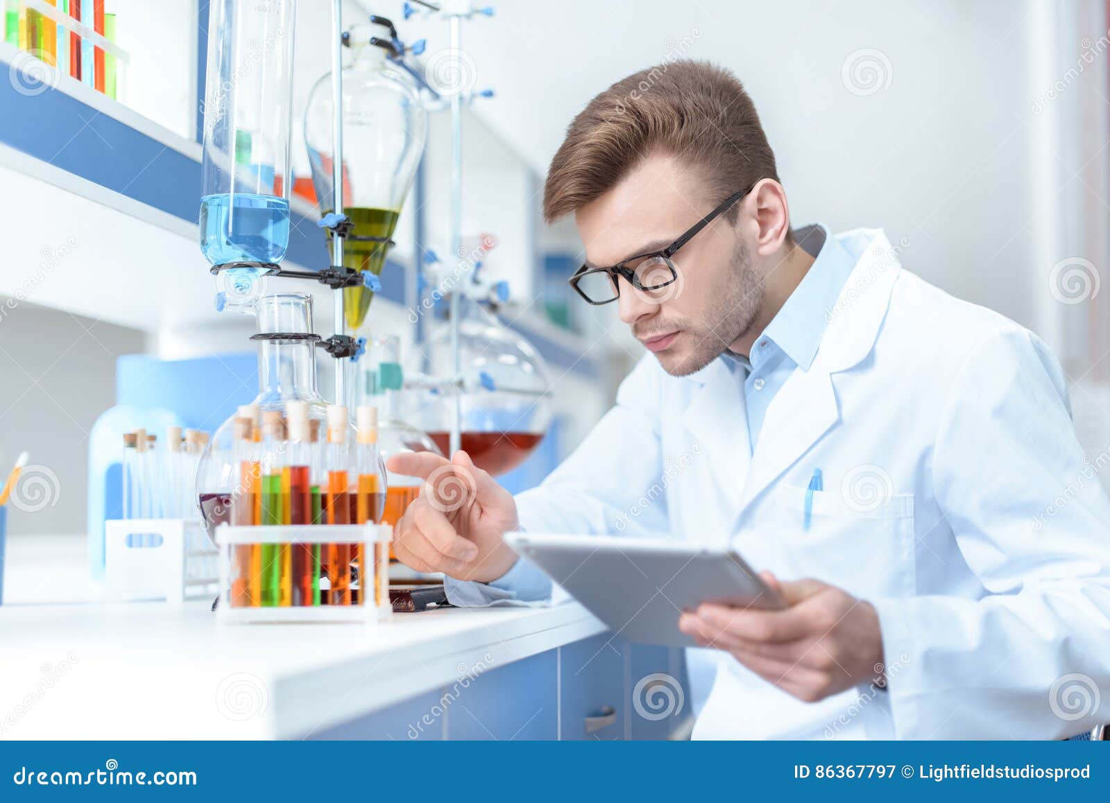 Scientist Holding Digital Tablet and Working with Test Tubes in Lab ...