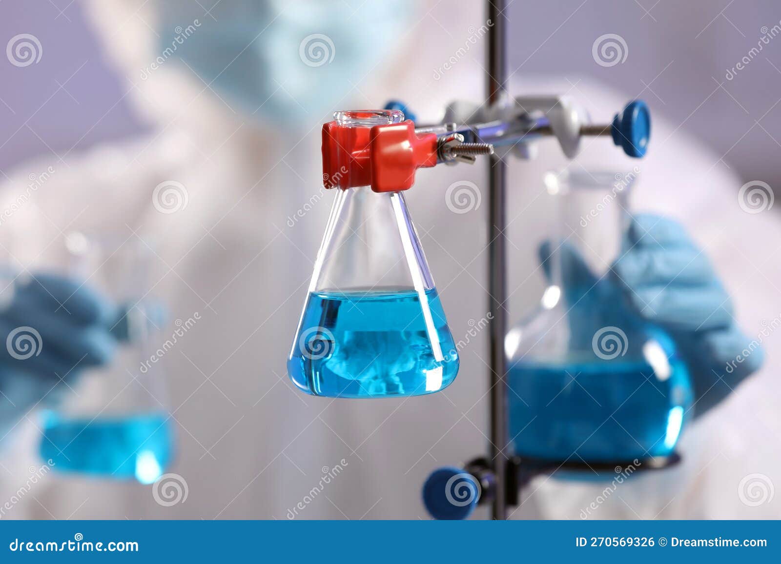 Scientist Holding Flasks with Light Blue Liquid on Grey Background ...
