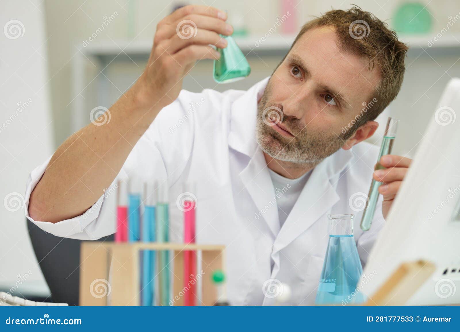 Scientist Holding Erlenmeyer Flask Up To Light Stock Image - Image of ...