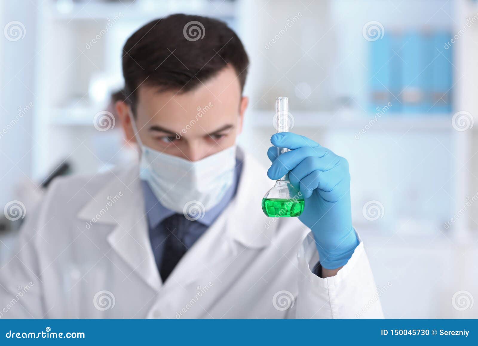 Scientist Holding Test Flask with Sample in Laboratory Stock Photo ...