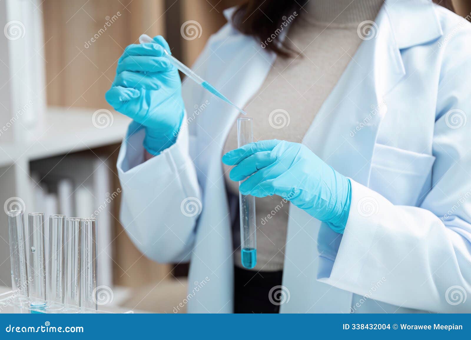 Scientist Conducting Experiment in Modern Laboratory with Test Tubes ...
