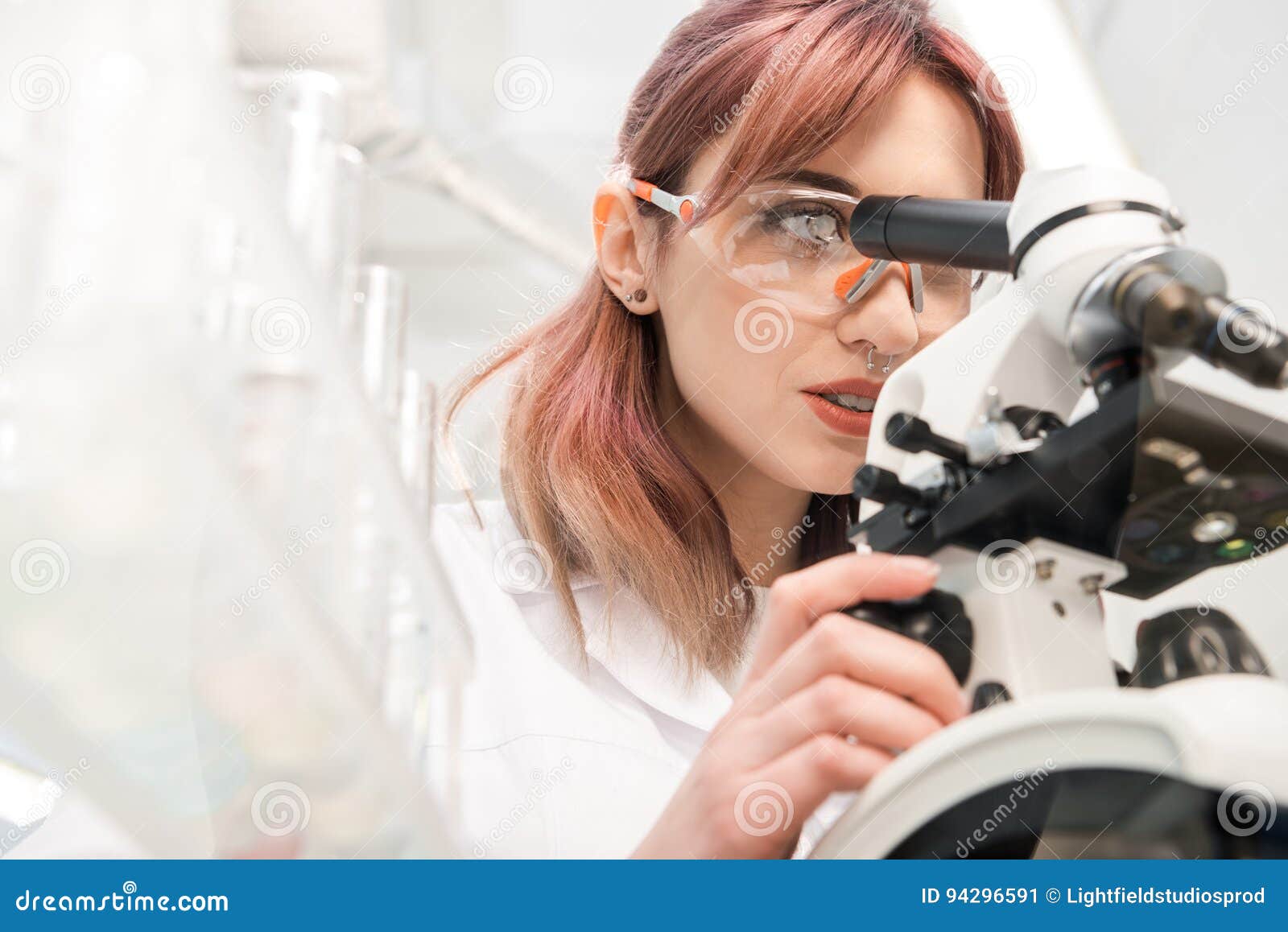 Scientist in Lab Coat Looking through Microscope in Laboratory Stock ...