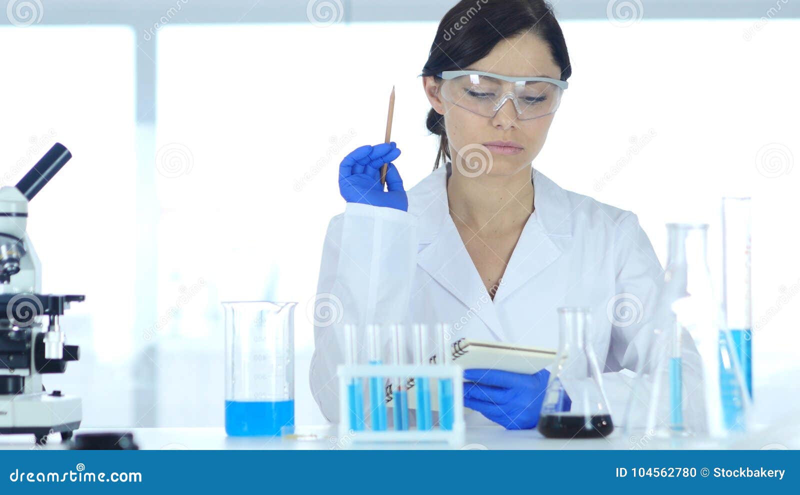 Scientist in Laboratory Reading Documents, Paperwork of Result of ...