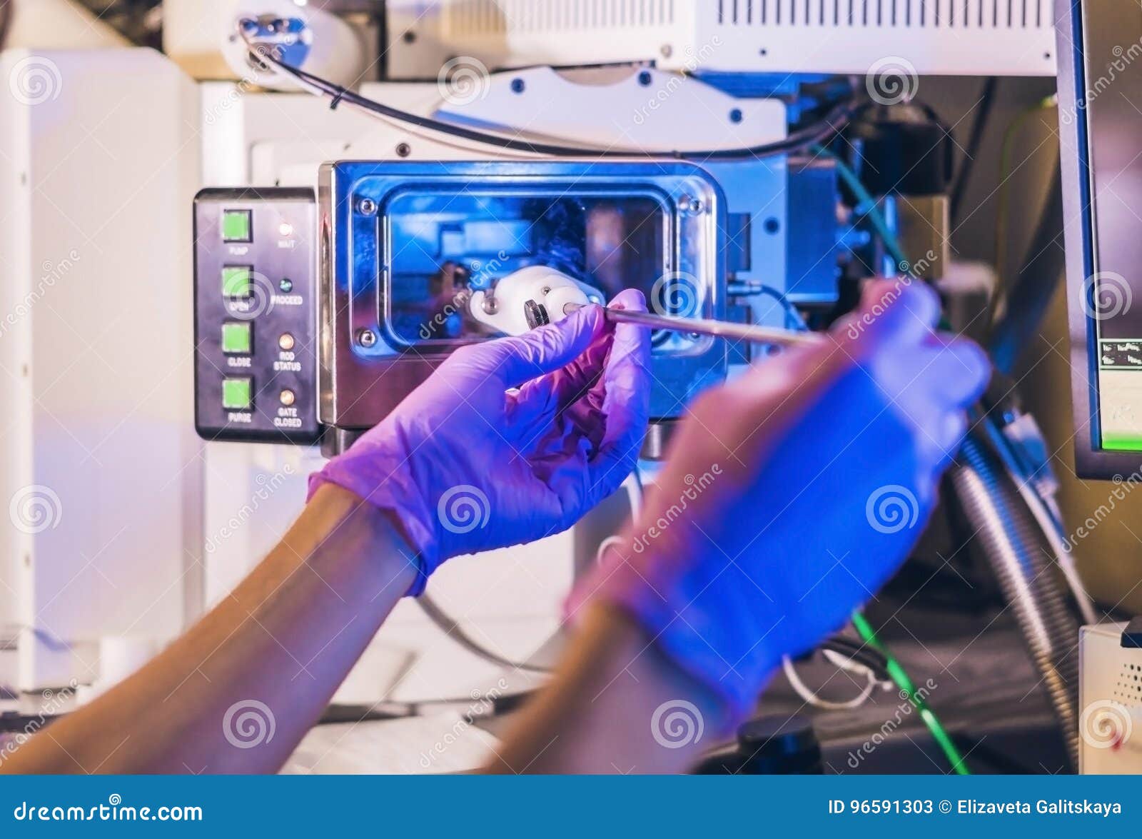 Scientist in a Laboratory Works with an Electron Microscope Gateway ...