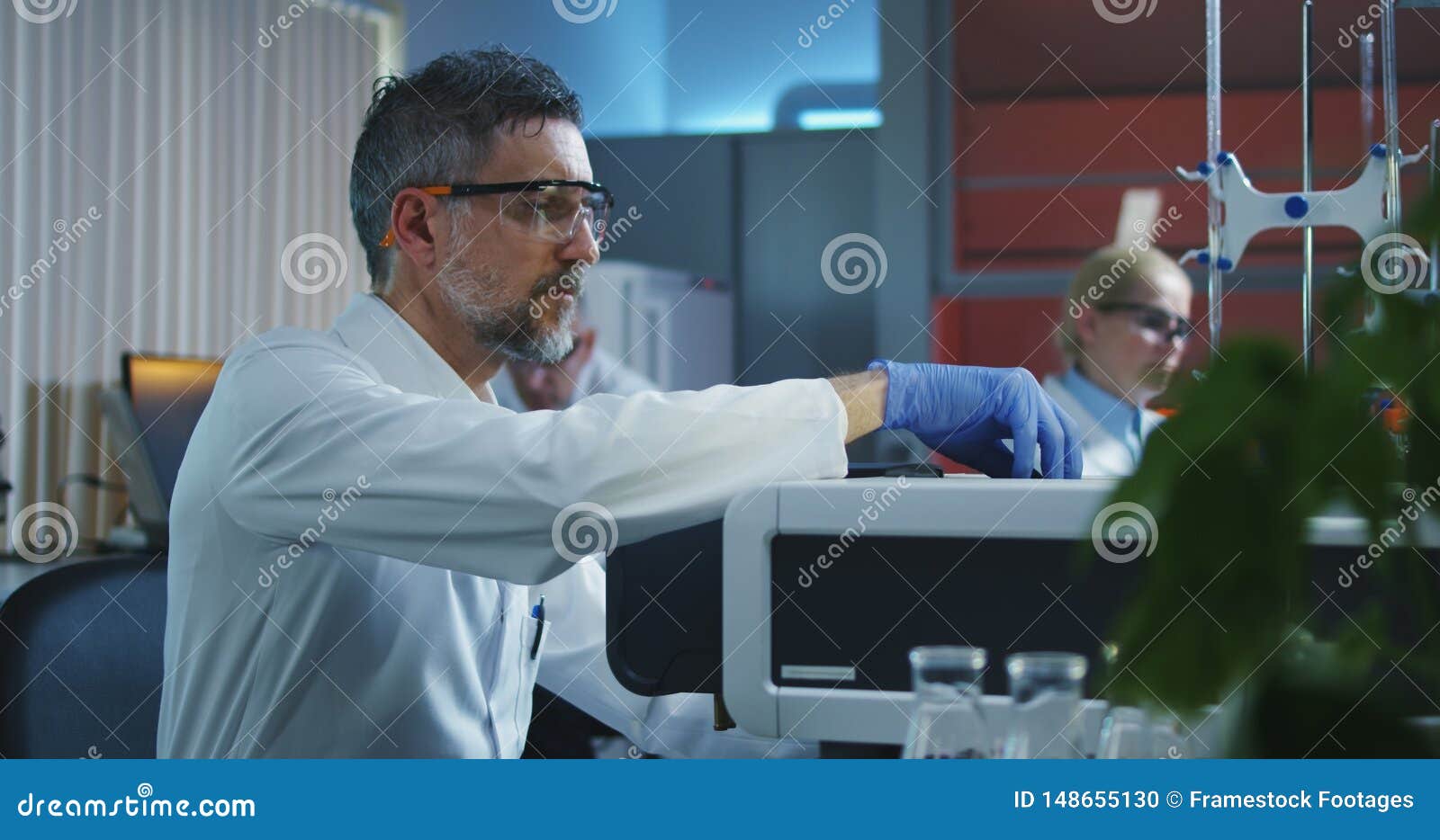 Scientist Loading Vials into a Testing Machine Stock Photo - Image of ...