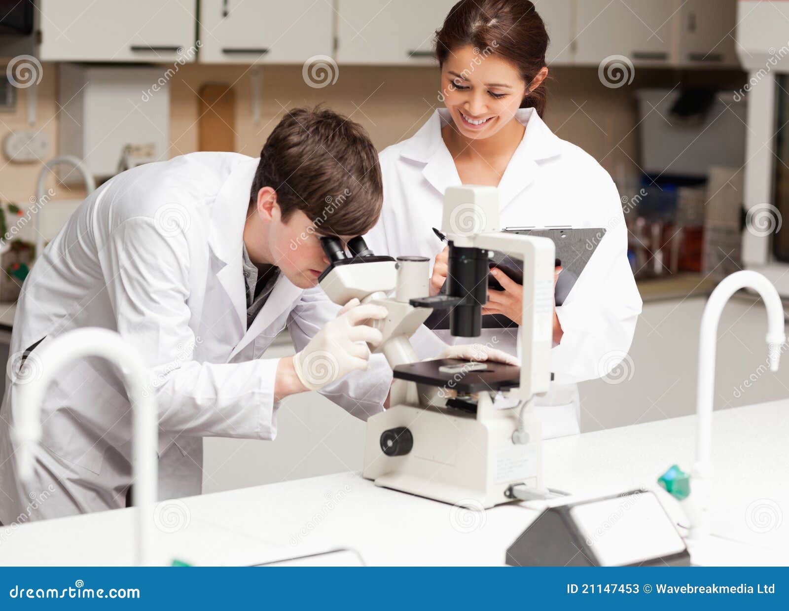 A Scientist Looking in a Microscope Stock Image - Image of microscope ...