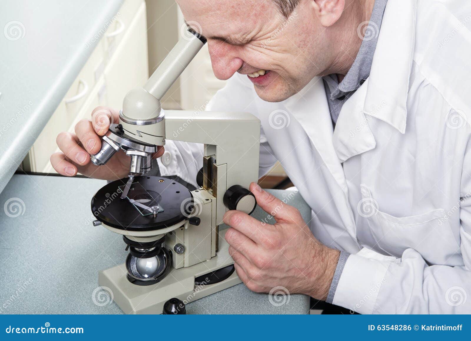 Scientist Looking through Microscope in Laboratory Stock Photo - Image ...