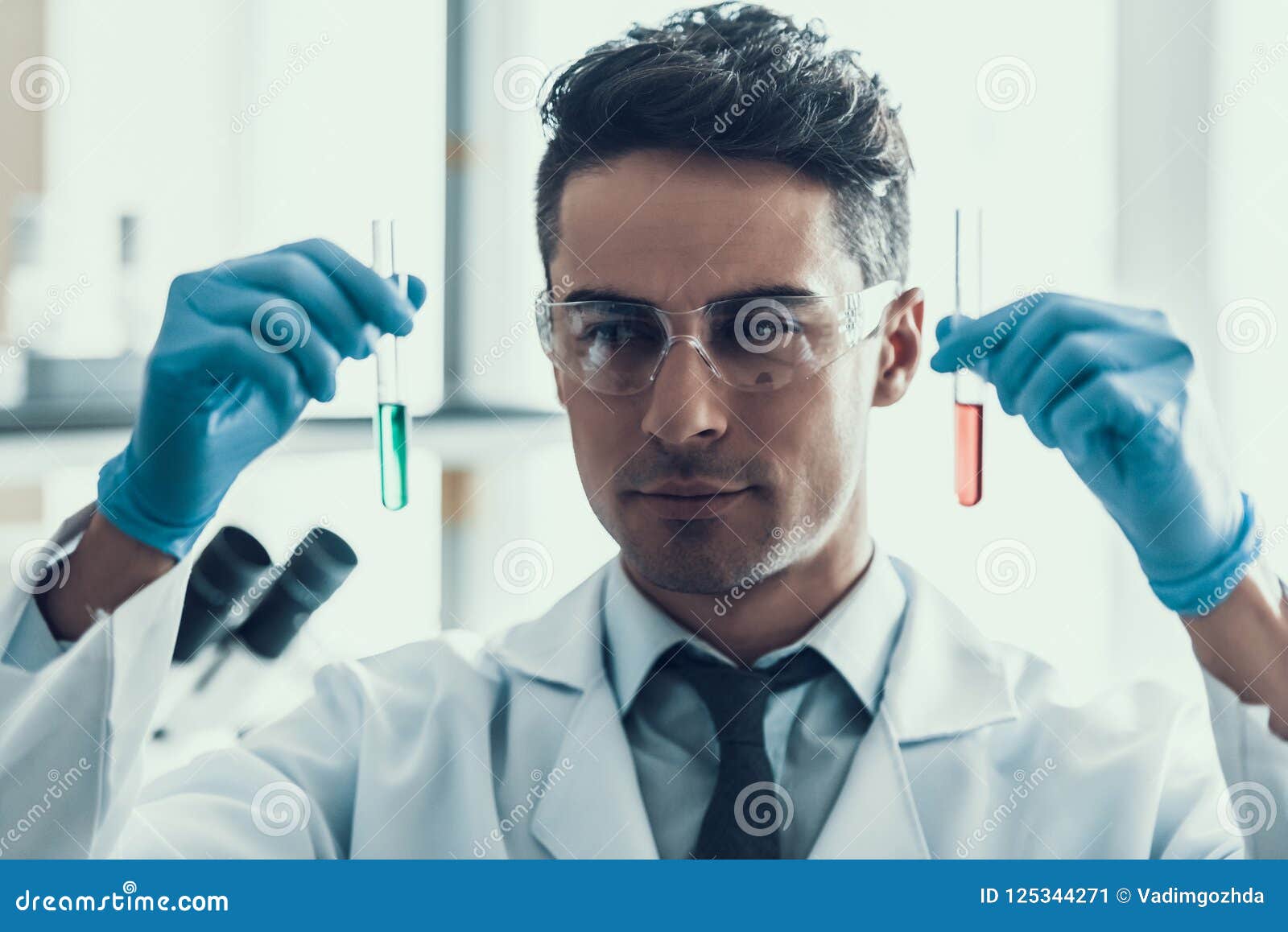 Scientist Looks at Liquid Samples in Flasks in Lab Stock Image - Image ...