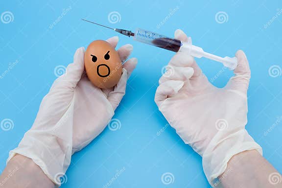 The Scientist Makes an Injection with a Syringe into the Egg Stock ...