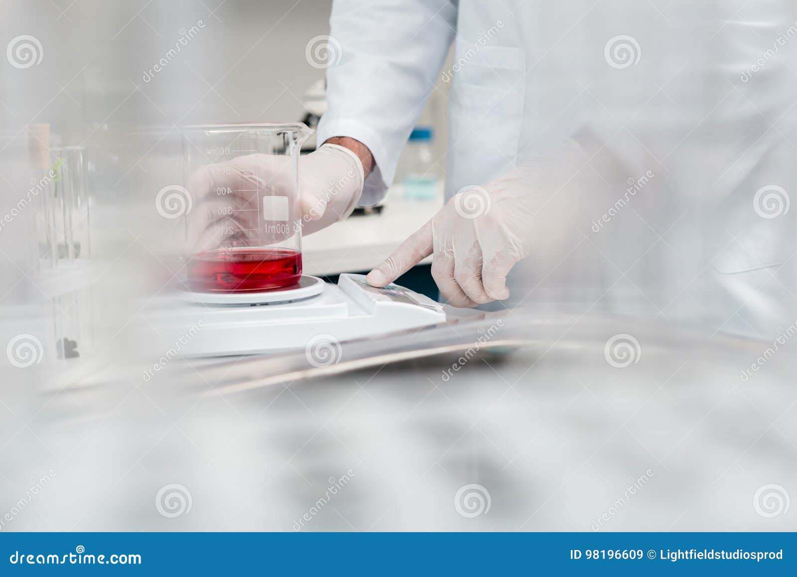 Scientist Making Experiment with Reagent in Flask and Electronic Scales ...