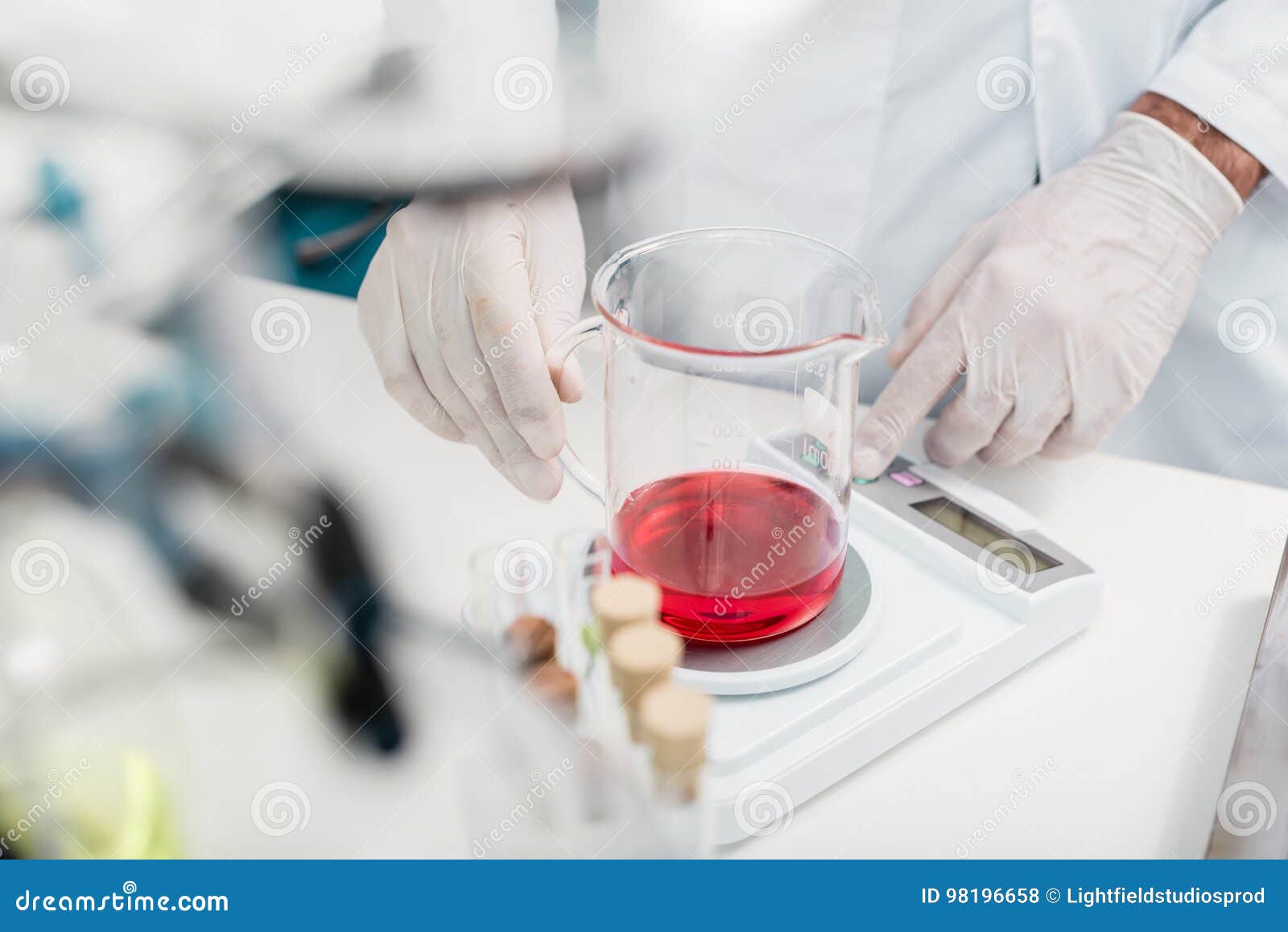 Scientist Making Experiment with Reagent in Flask and Electronic Scales ...