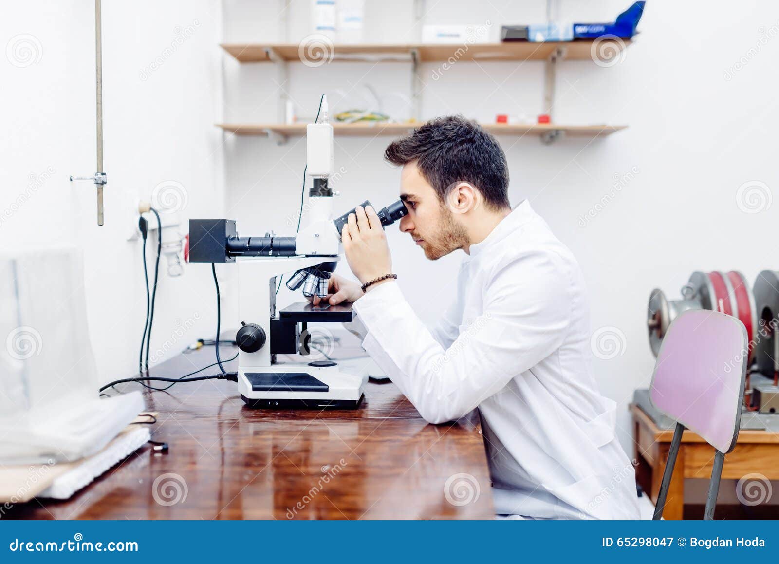 Scientist with Microscope, Examining Samples and Contaminated Probes in ...