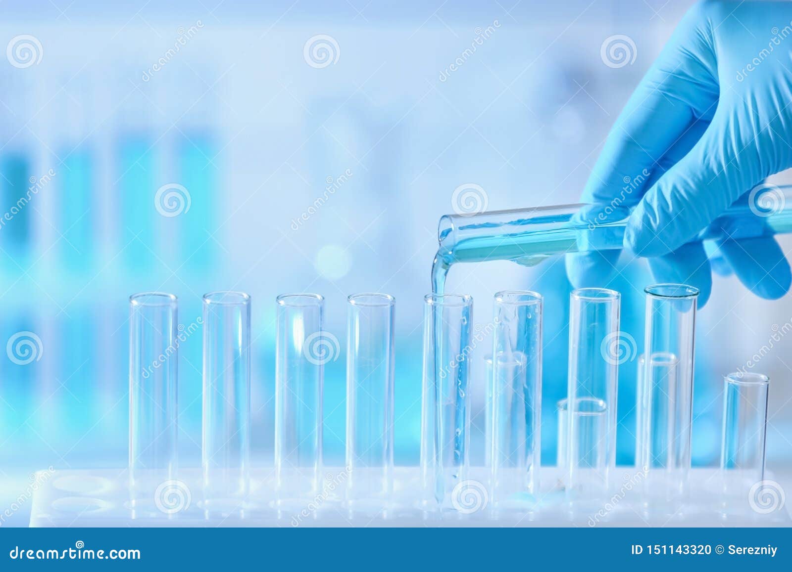 Scientist Pouring Color Liquid into Test Tubes in Laboratory Stock ...