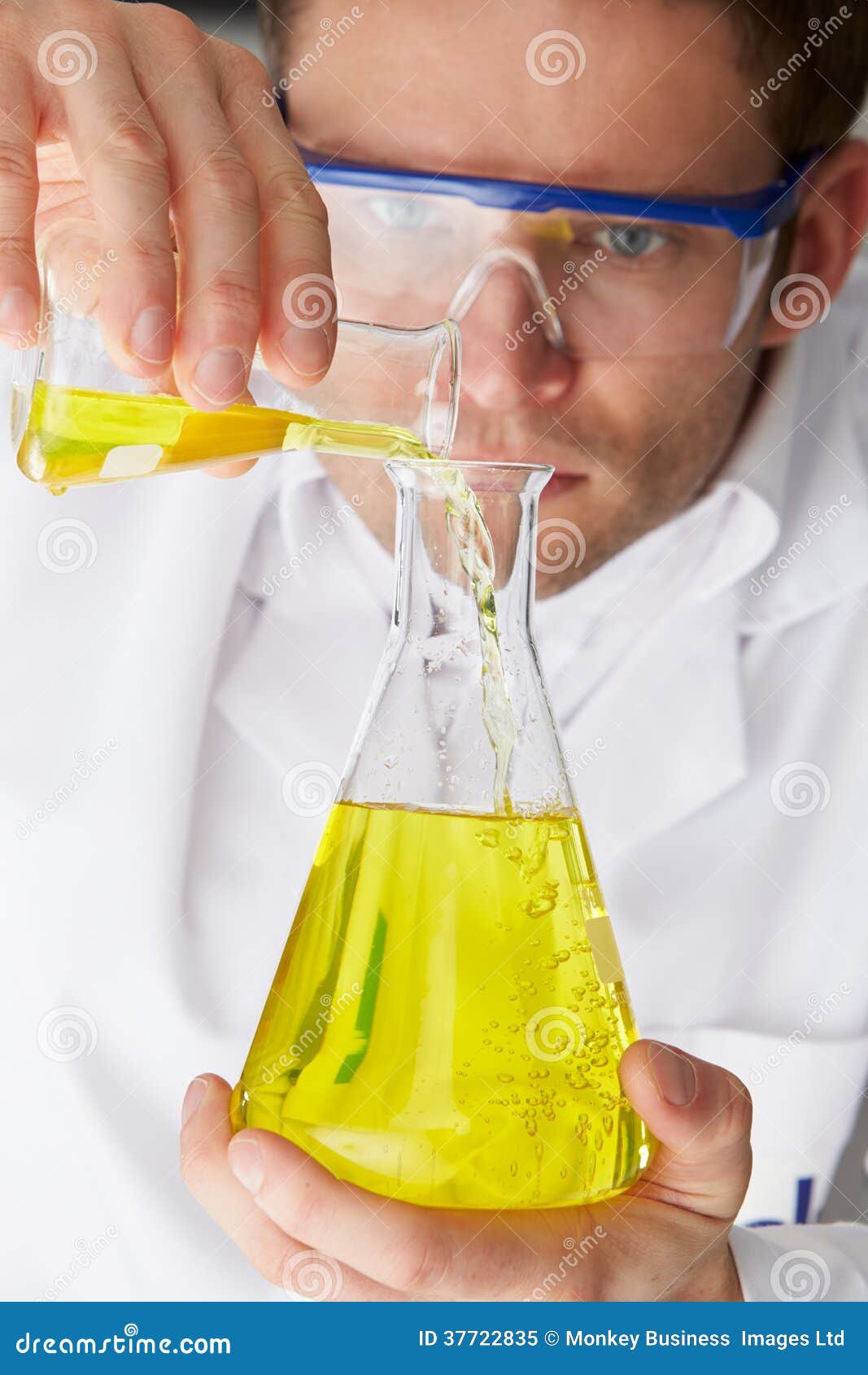 Scientist Pouring Liquid from Test Tube into Flask Stock Image - Image ...