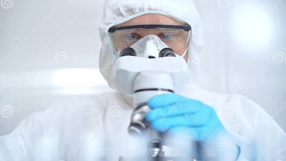 Scientist in Ppe Analyzing Samples Using a Microscope in a Laboratory ...
