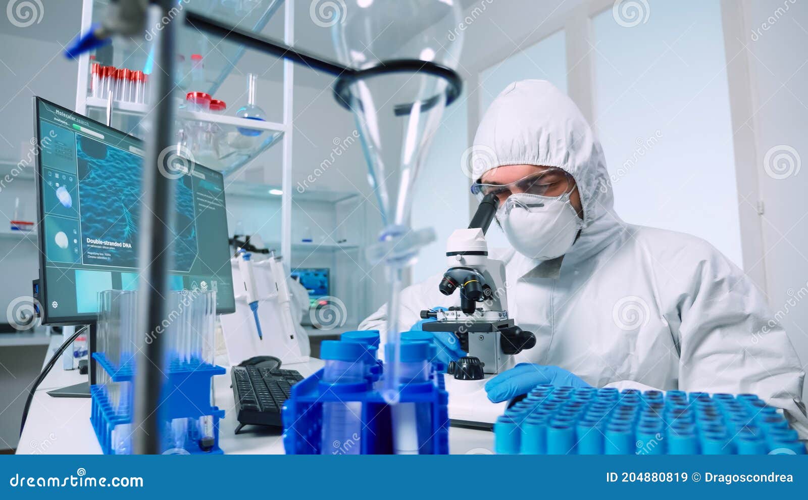 Scientist in Ppe Suit Conducting Experiment Using Microscope Stock ...