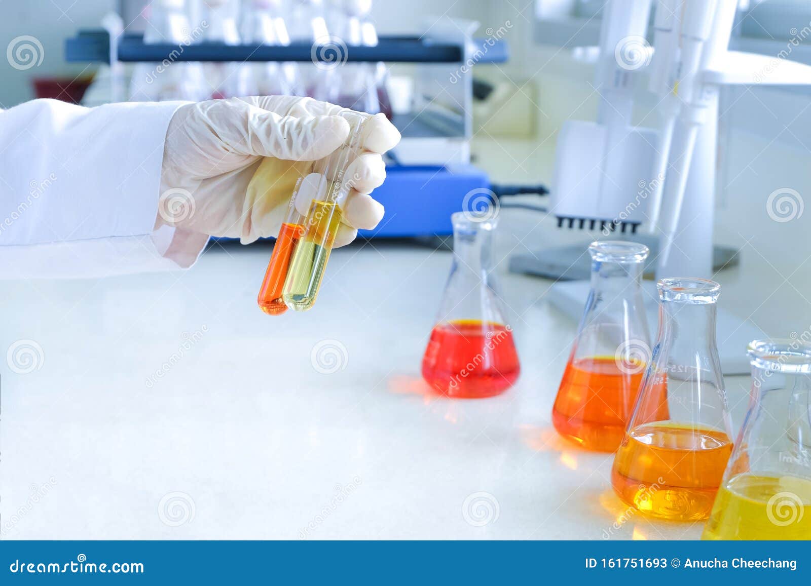 Scientist is Preparation Test Tubes and Orange Liquid in Flask in ...