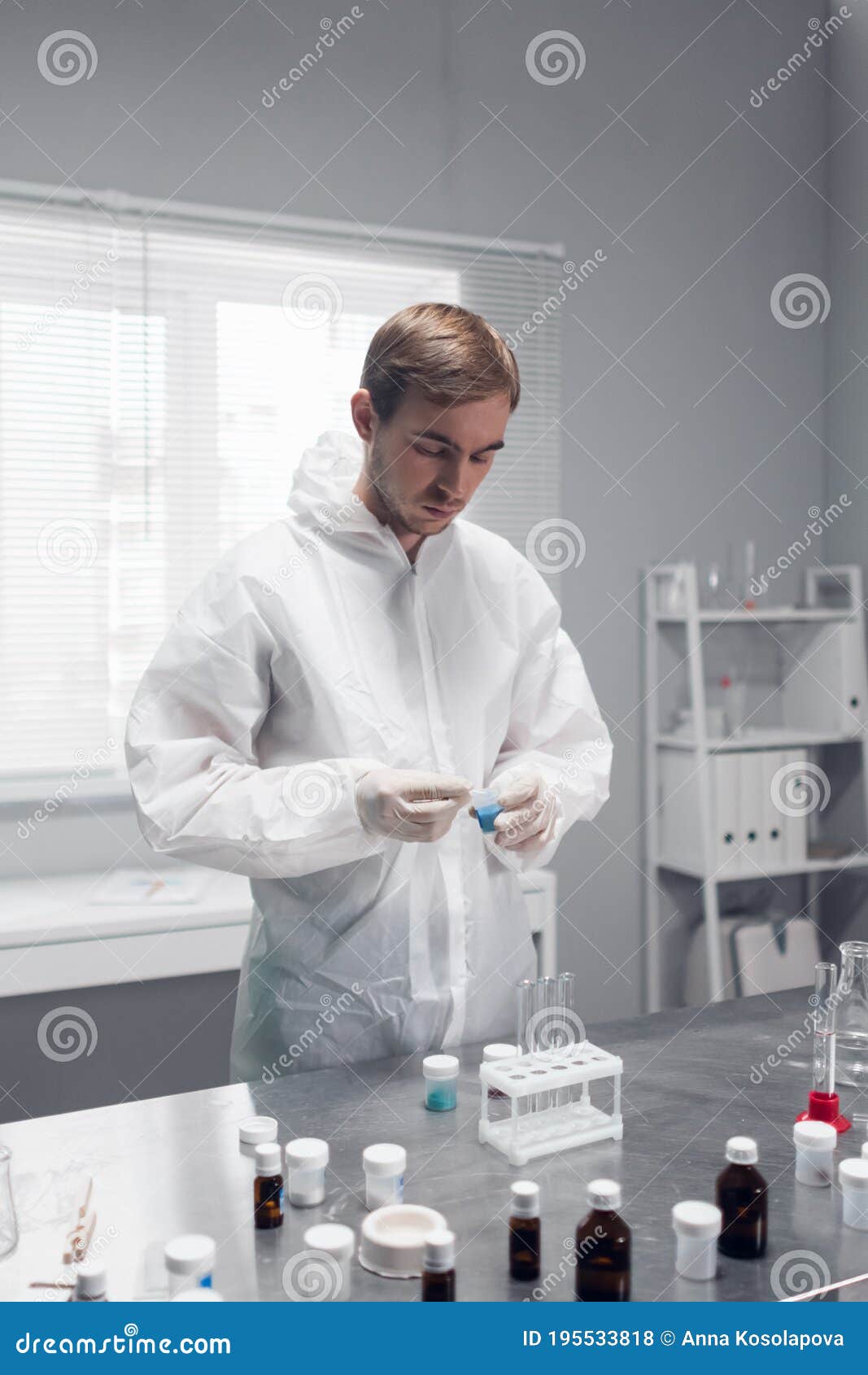 A Scientist in Protective Clothing Standing at the Table in the Science ...