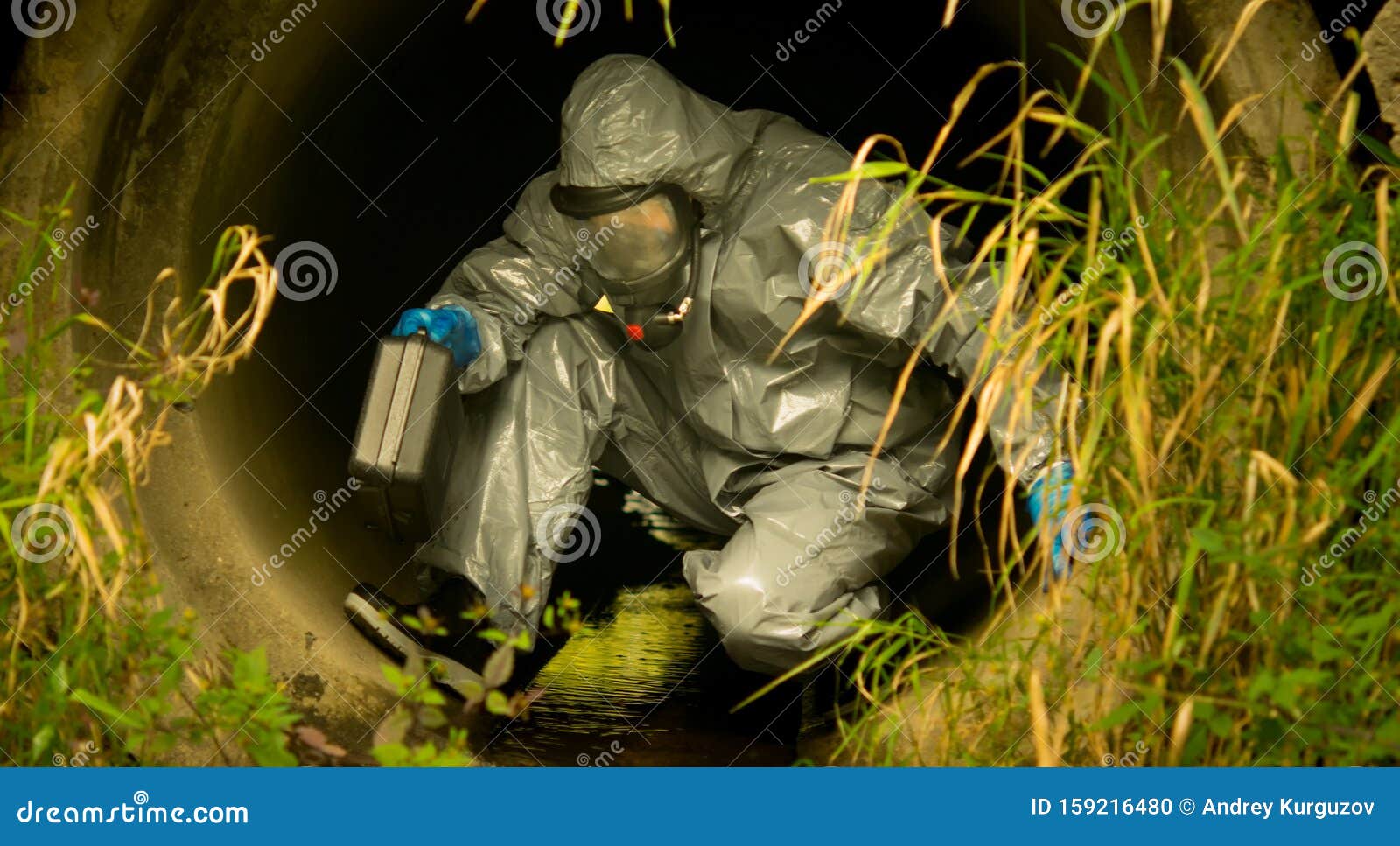 Scientist in Protective Clothing, with a Suitcase Comes into the Drain ...