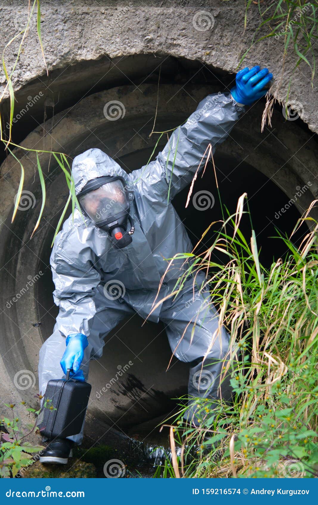 Scientist in Protective Clothing, with a Suitcase Out of the Drain Pipe ...