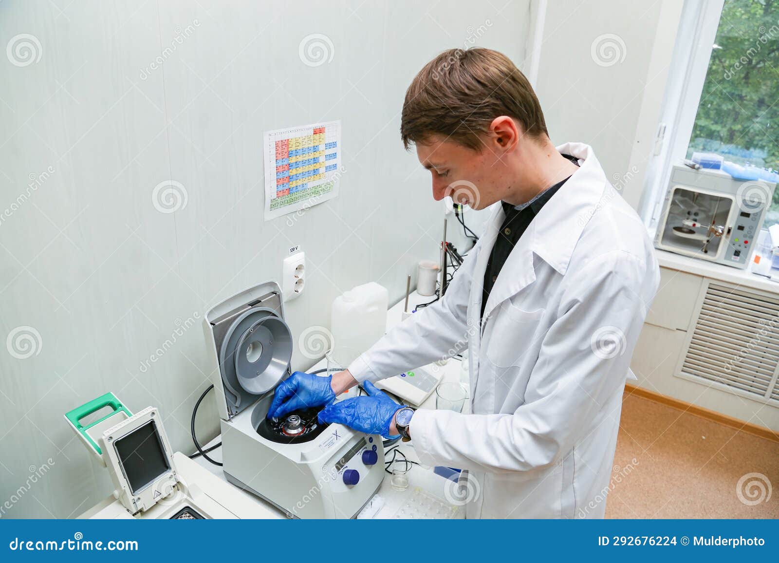 Scientist Puts Microcentrifuge Tubes Into Centrifuge For Phase ...