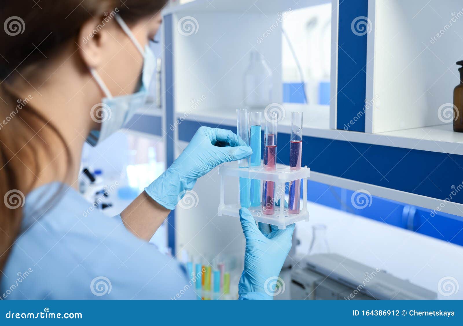 Scientist Putting Sample Compartment With Liquid In Spectrophotometer ...