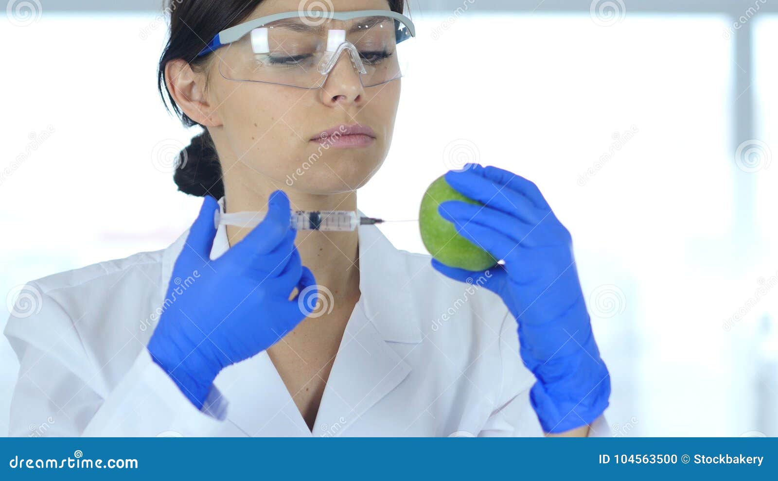 Scientist Ready To Inject Apple with Solution in Laboratory Stock Photo ...