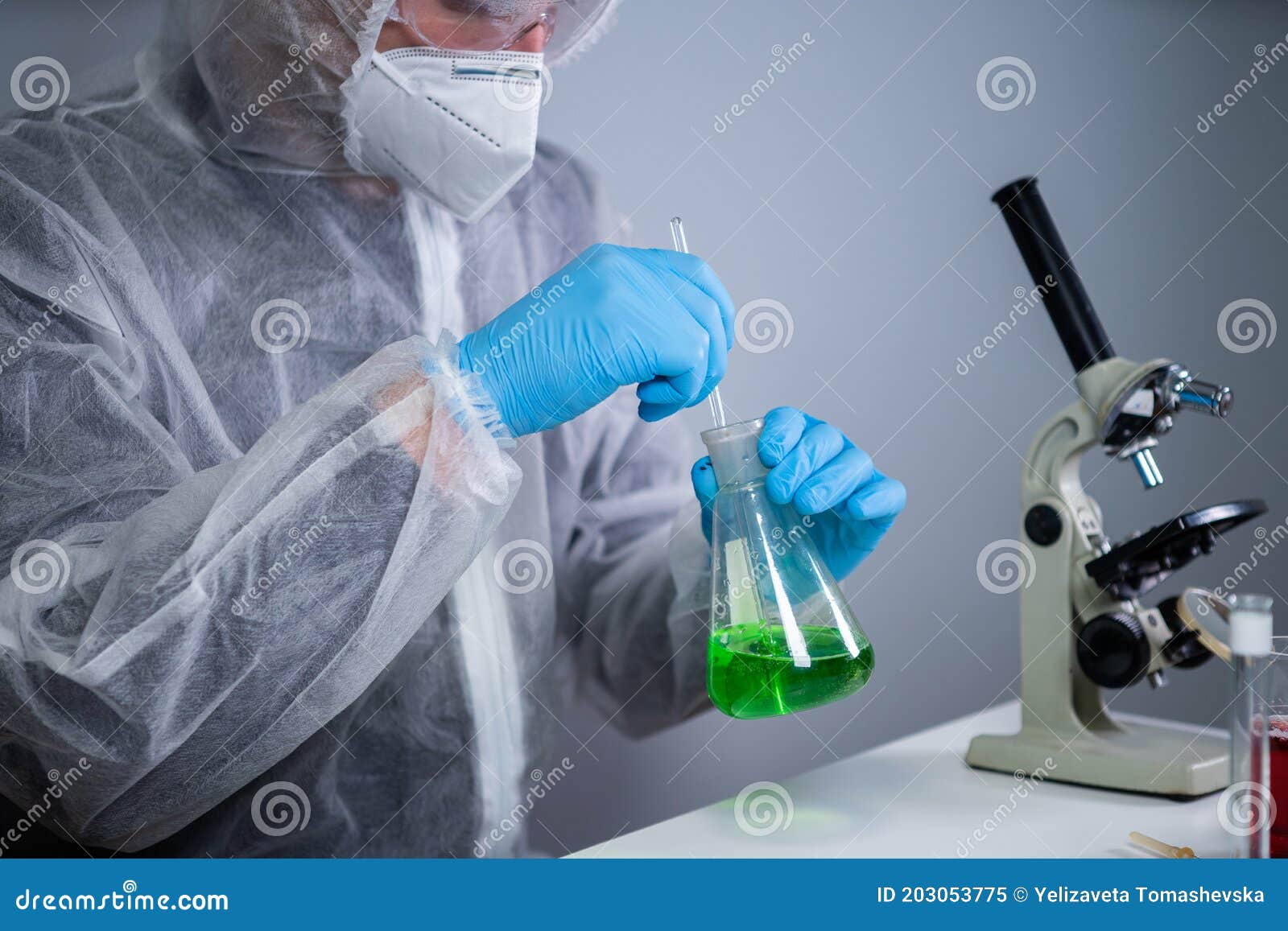 Scientist Shaking Green Fluid in Beaker. Young Laboratory Assistant ...