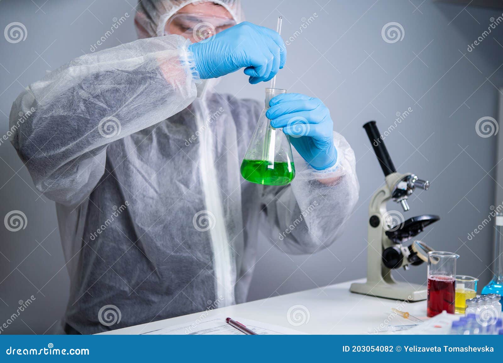 Scientist Shaking Green Fluid in Beaker. Young Laboratory Assistant ...