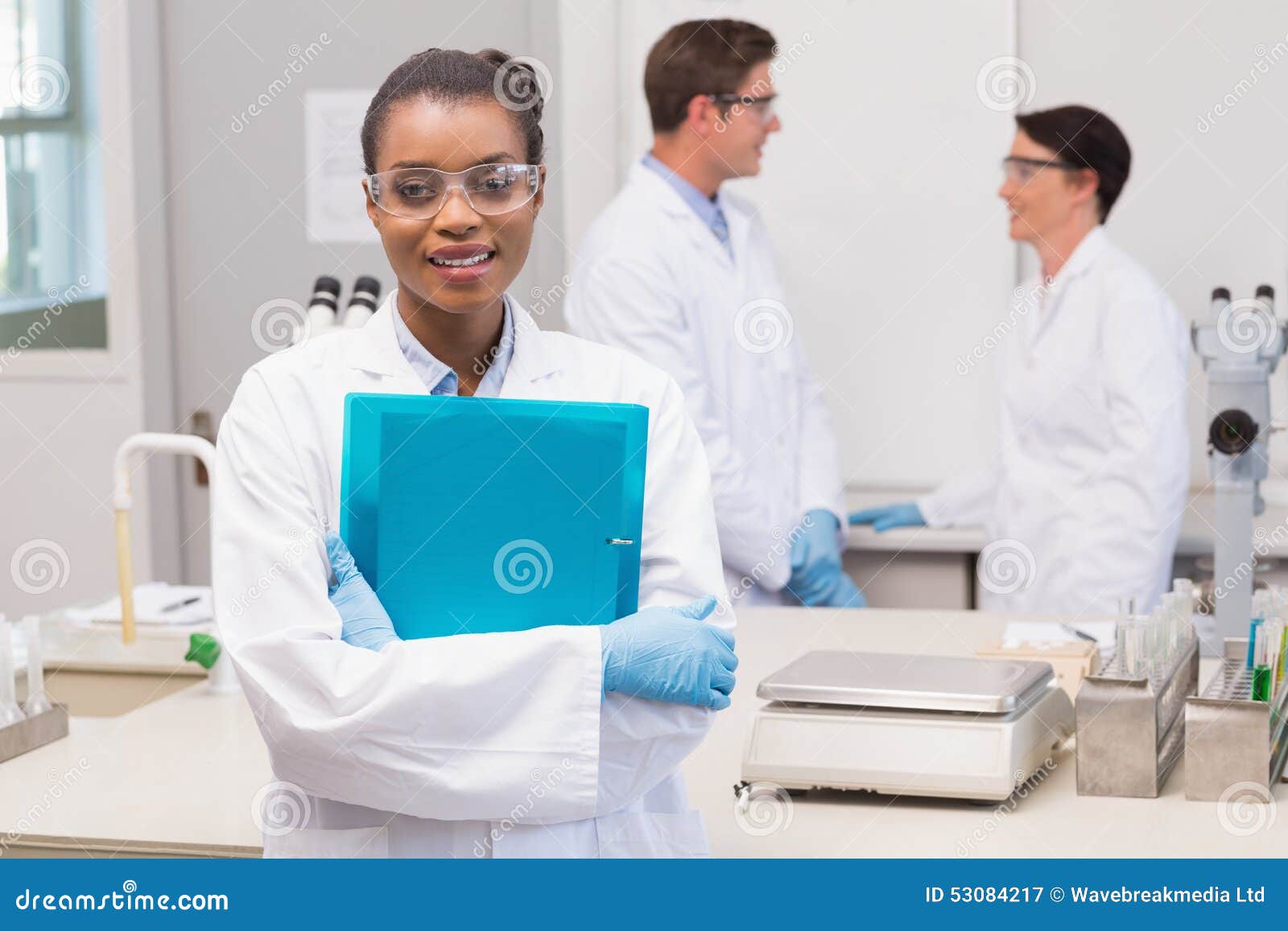 Scientist Smiling at Camera while Colleagues Talking Together Stock ...