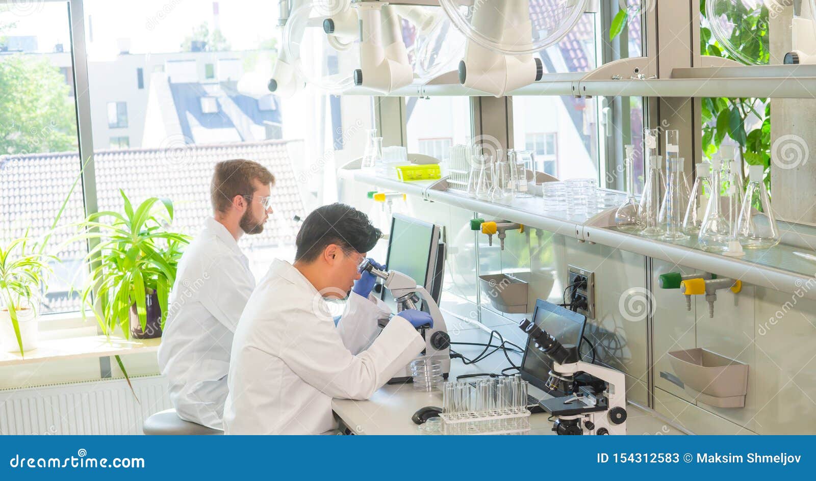 Scientist and Students Working in Lab. Doctor Teaching Interns To Make ...