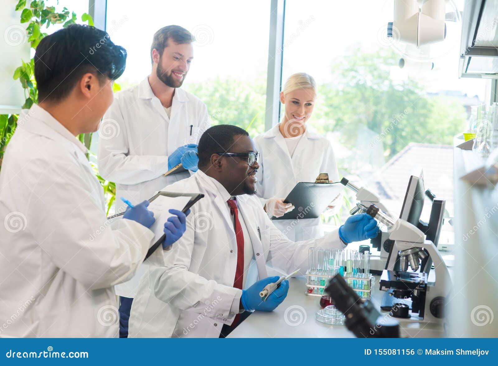 Scientist and Students Working in Lab. Doctor Teaching Interns To Make ...