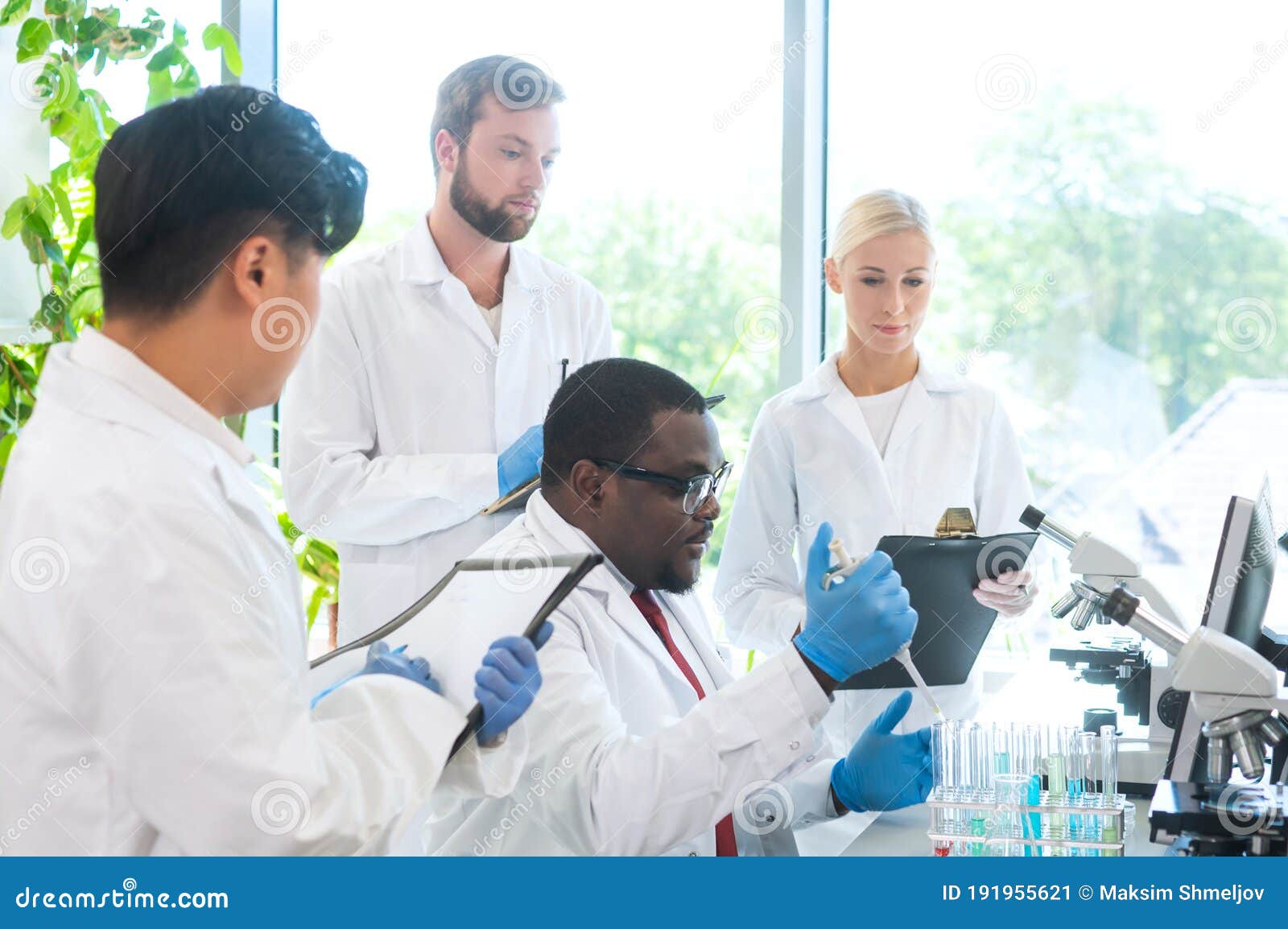 Scientist and Students Working in Lab. Doctor Teaching Interns To Make ...