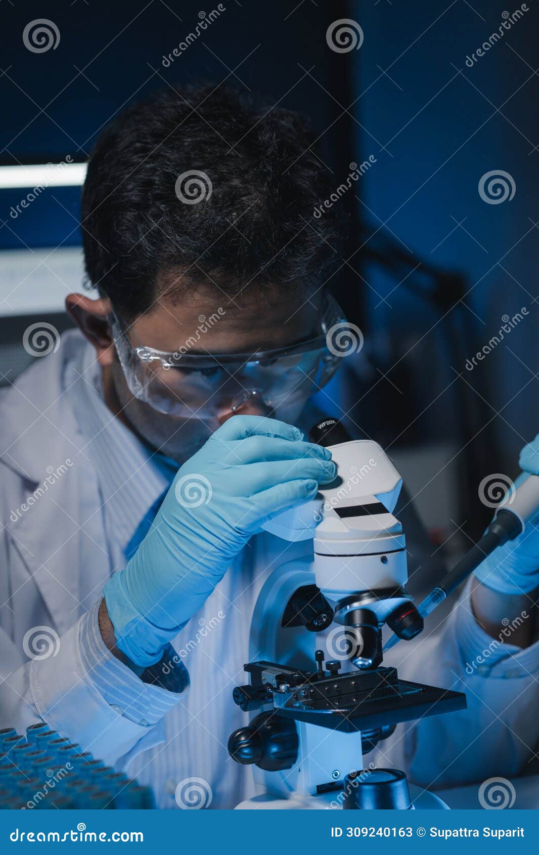 A Scientist is Studying Samples Using a Microscope To Study and Develop ...