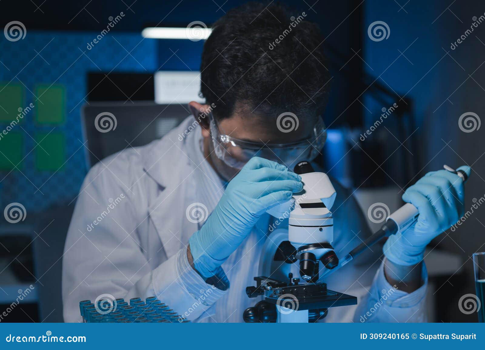 A Scientist is Studying Samples Using a Microscope To Study and Develop ...