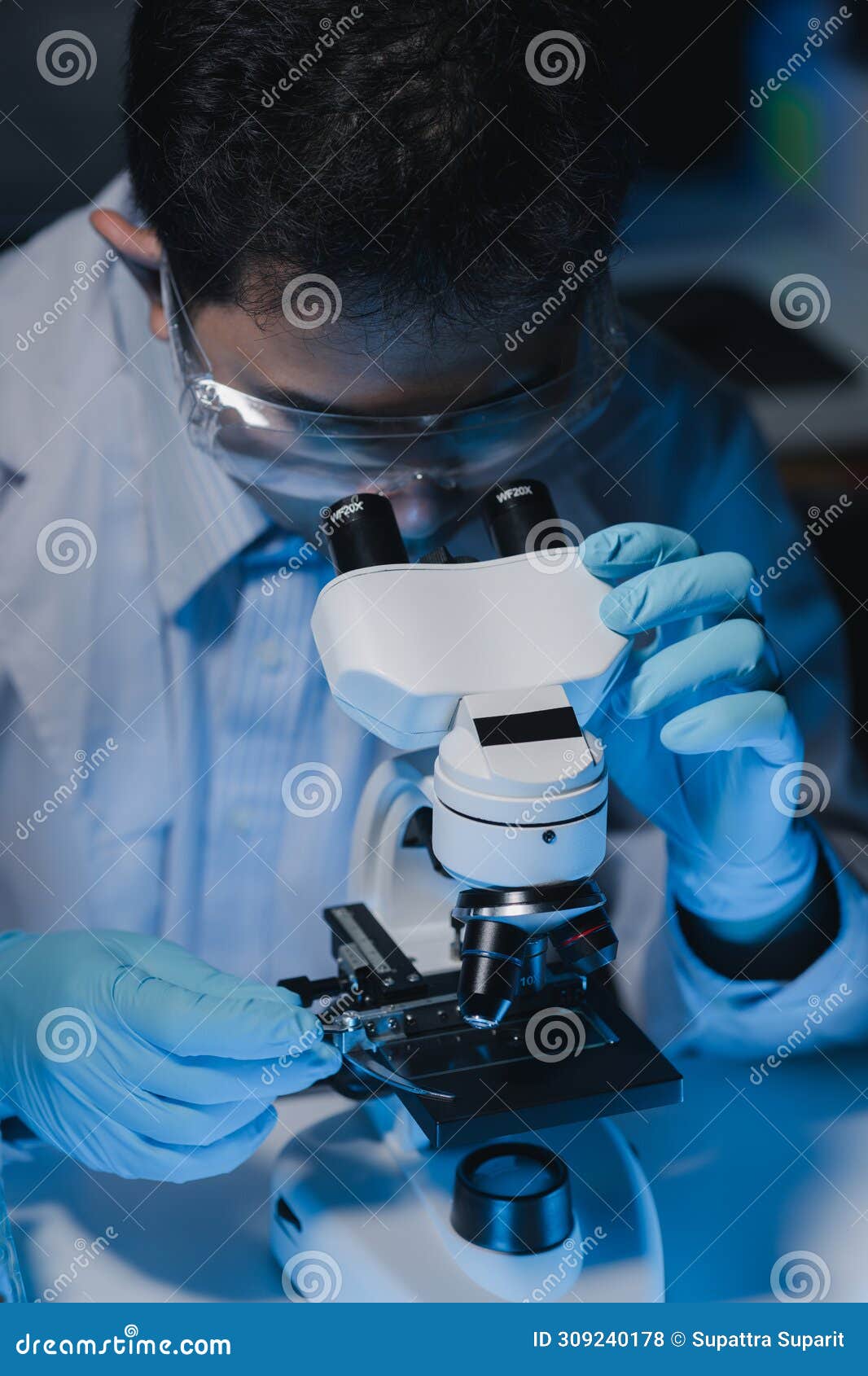 A Scientist is Studying Samples Using a Microscope To Study and Develop ...