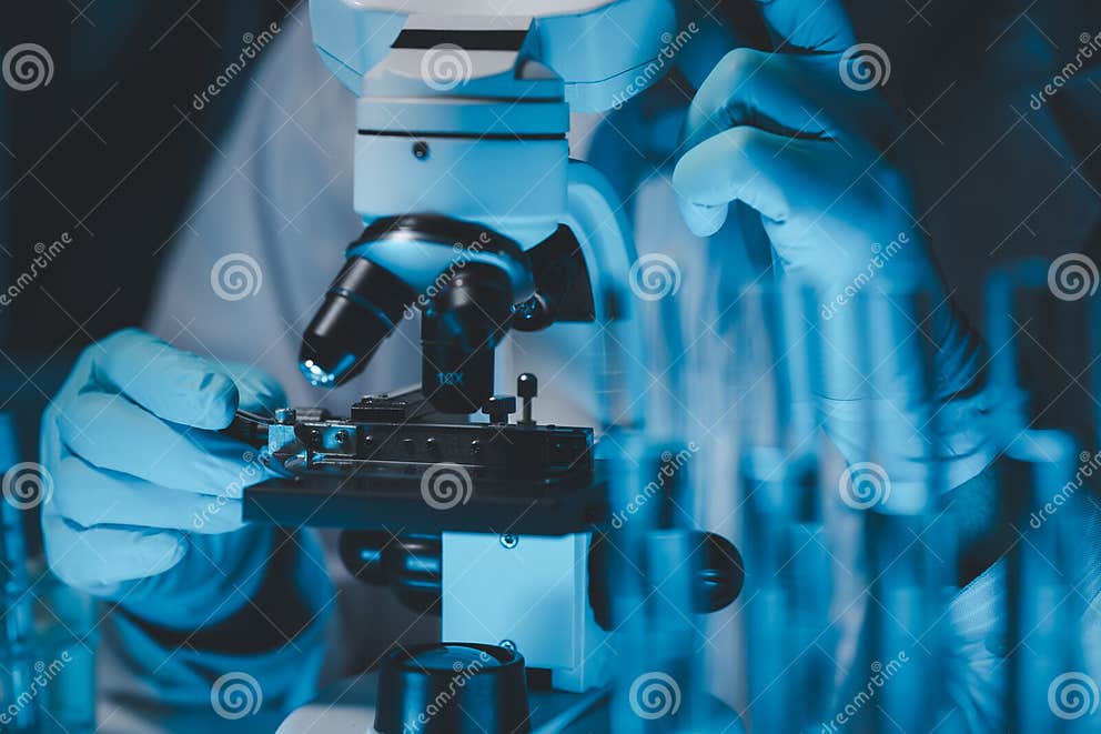 A Scientist is Studying Samples Using a Microscope To Study and Develop the Field of ...
