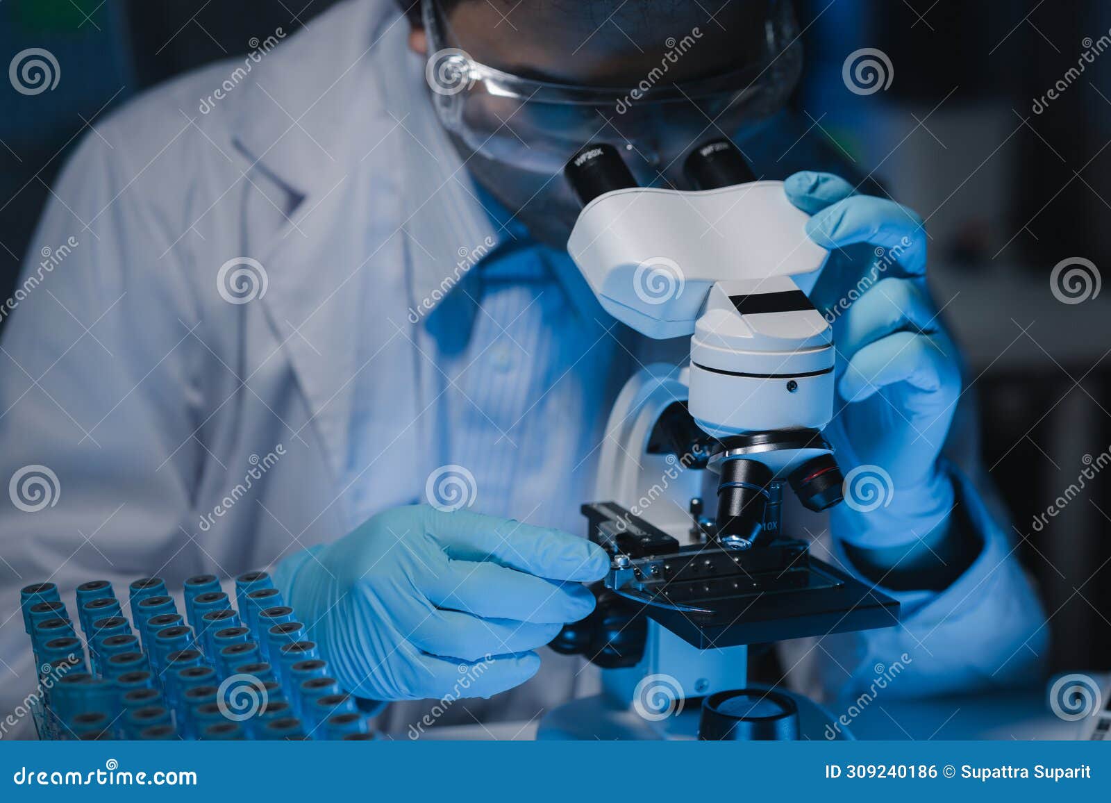 A Scientist is Studying Samples Using a Microscope To Study and Develop ...