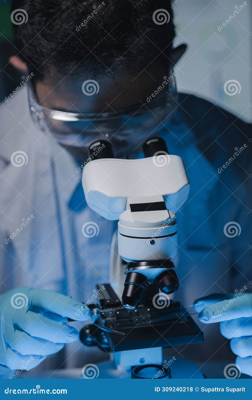 A Scientist is Studying Samples Using a Microscope To Study and Develop ...