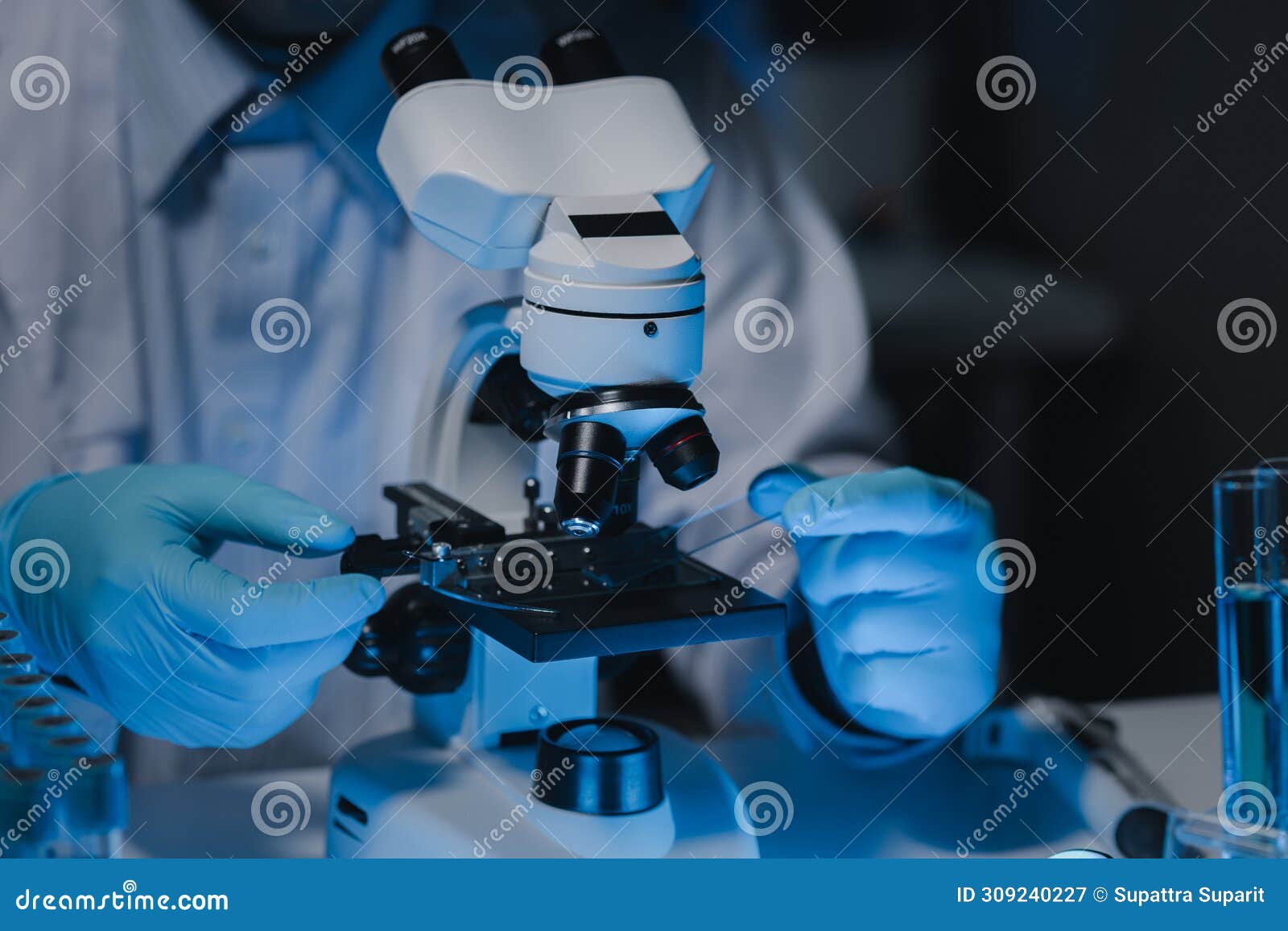 A Scientist is Studying Samples Using a Microscope To Study and Develop ...