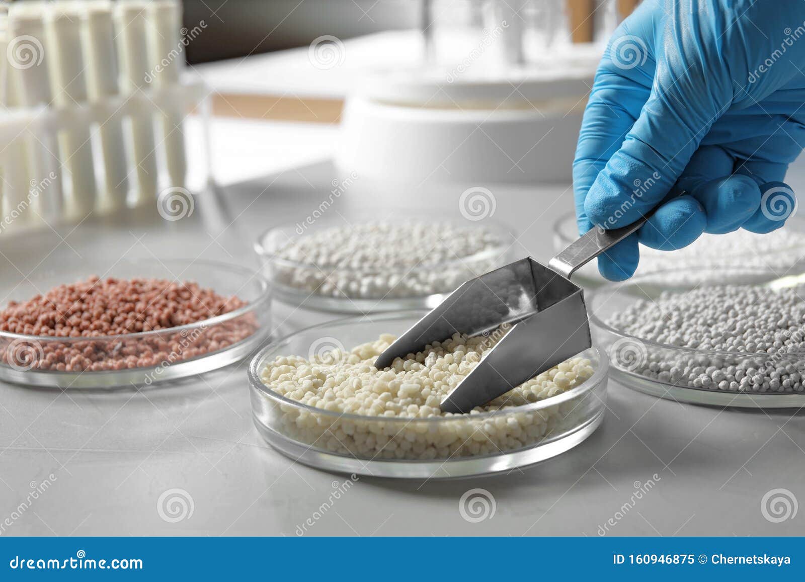 Scientist Taking Mineral Fertilizer with Scoop at Table. Laboratory ...